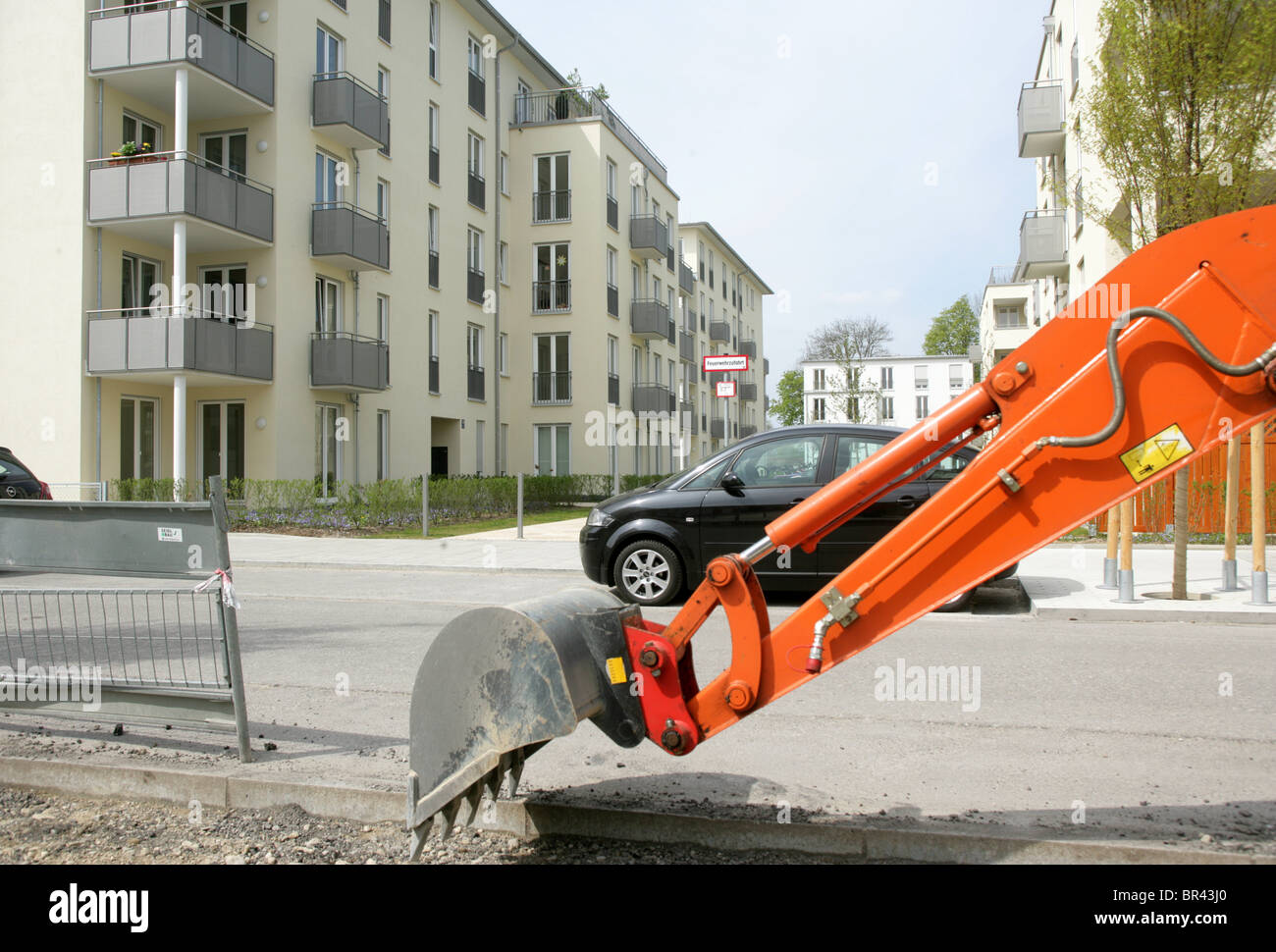 Digger at residential neighborhood in Munich, Germany Stock Photo - Alamy