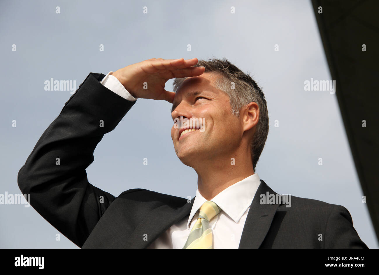 Smiling businessman outdoors looking around Stock Photo - Alamy