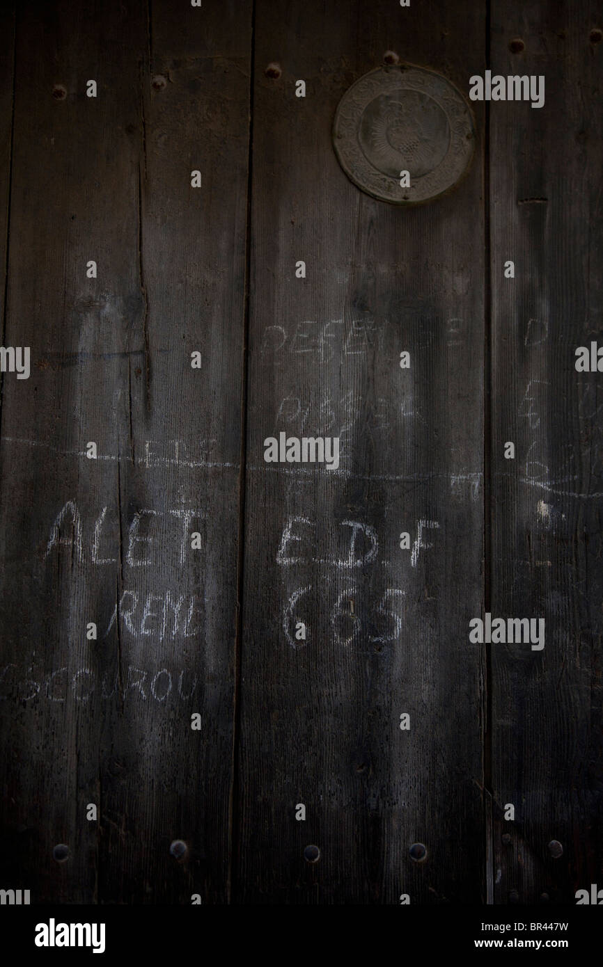 Old wooden door with scratched graffiti Stock Photo - Alamy