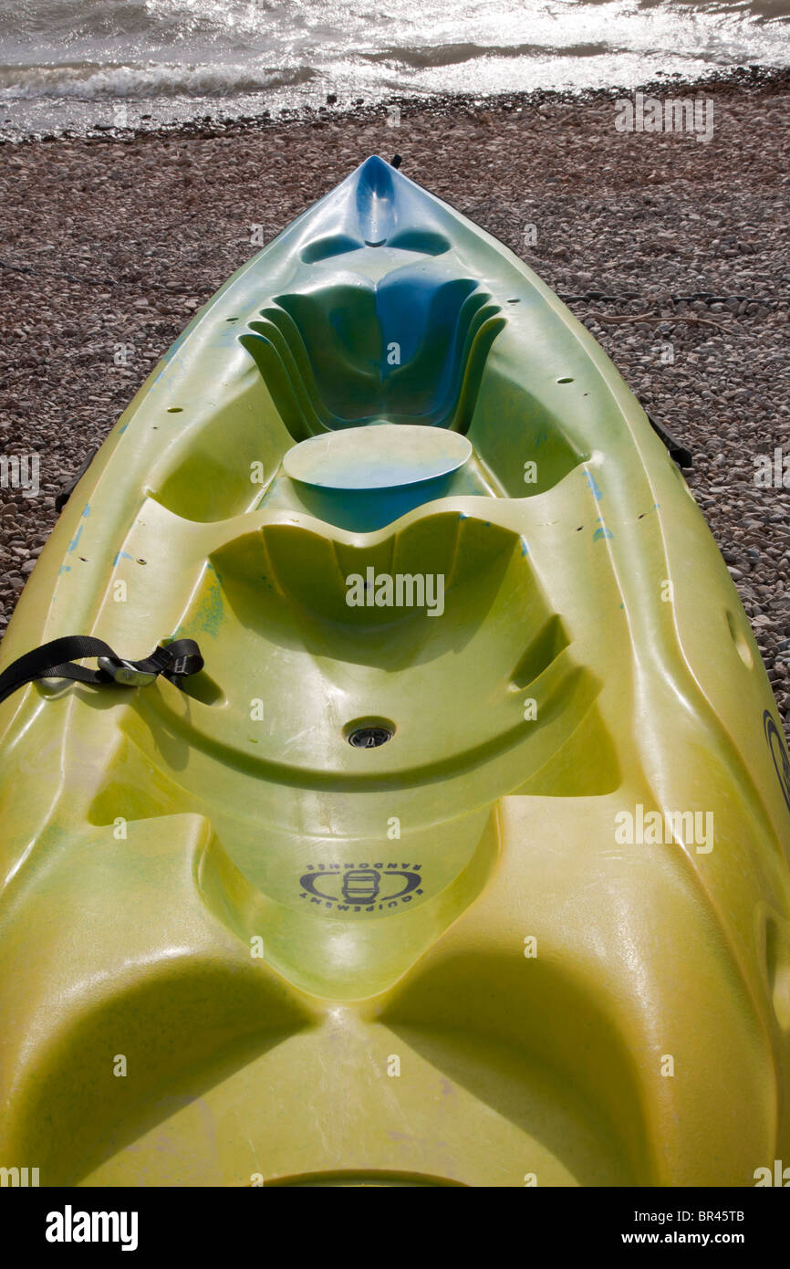 Brightly colored sea kayak on the beach Stock Photo - Alamy