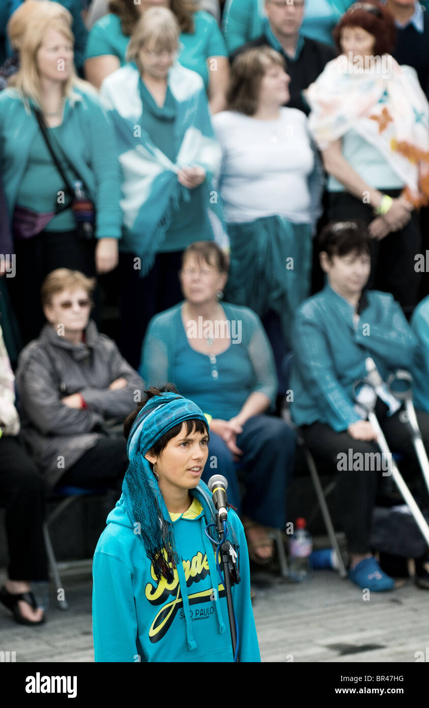 A female singer with a choir performing for Water Aid as part of the ...