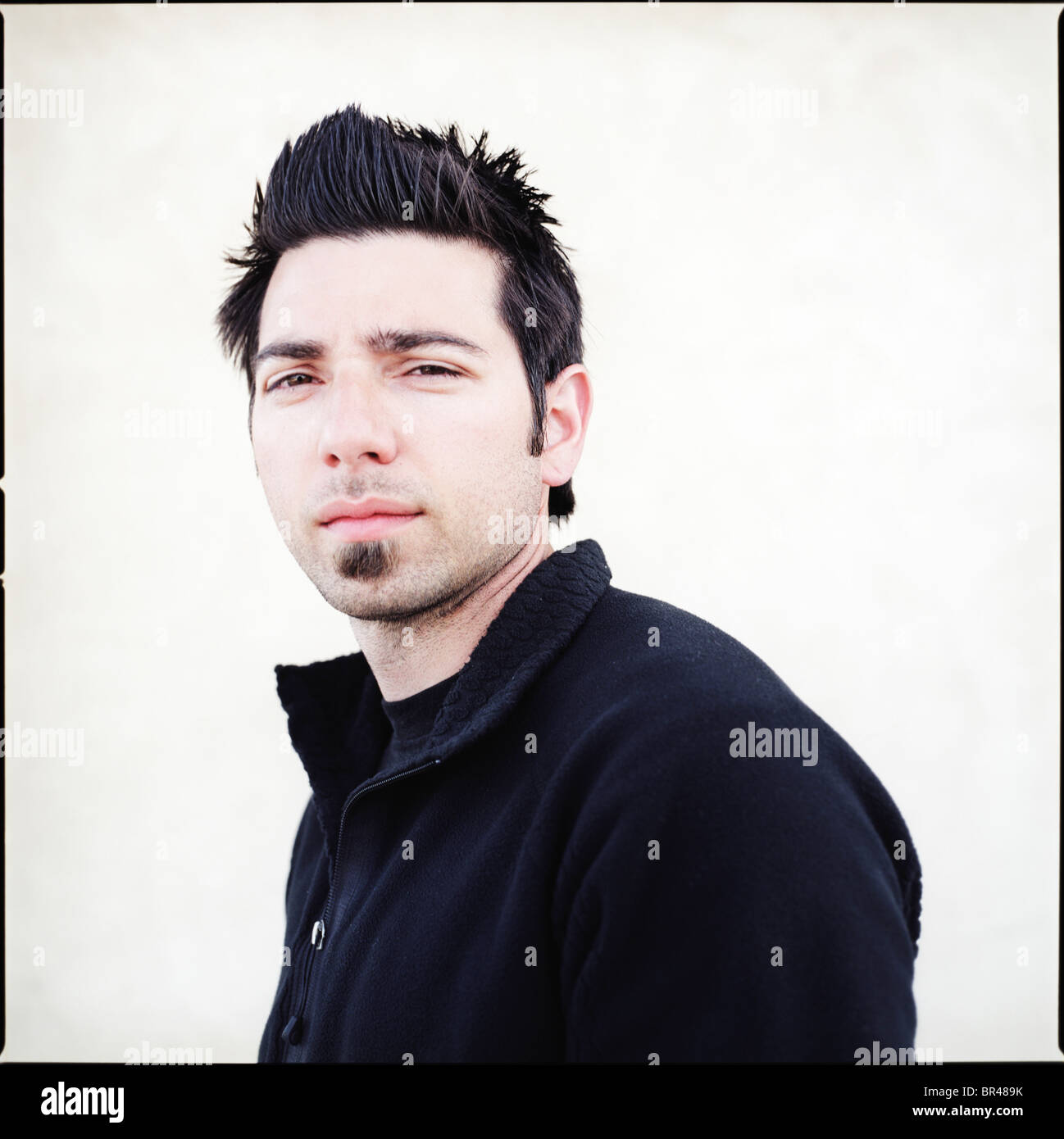 A handsome young man with dark hair poses for a portrait near El Paso ...