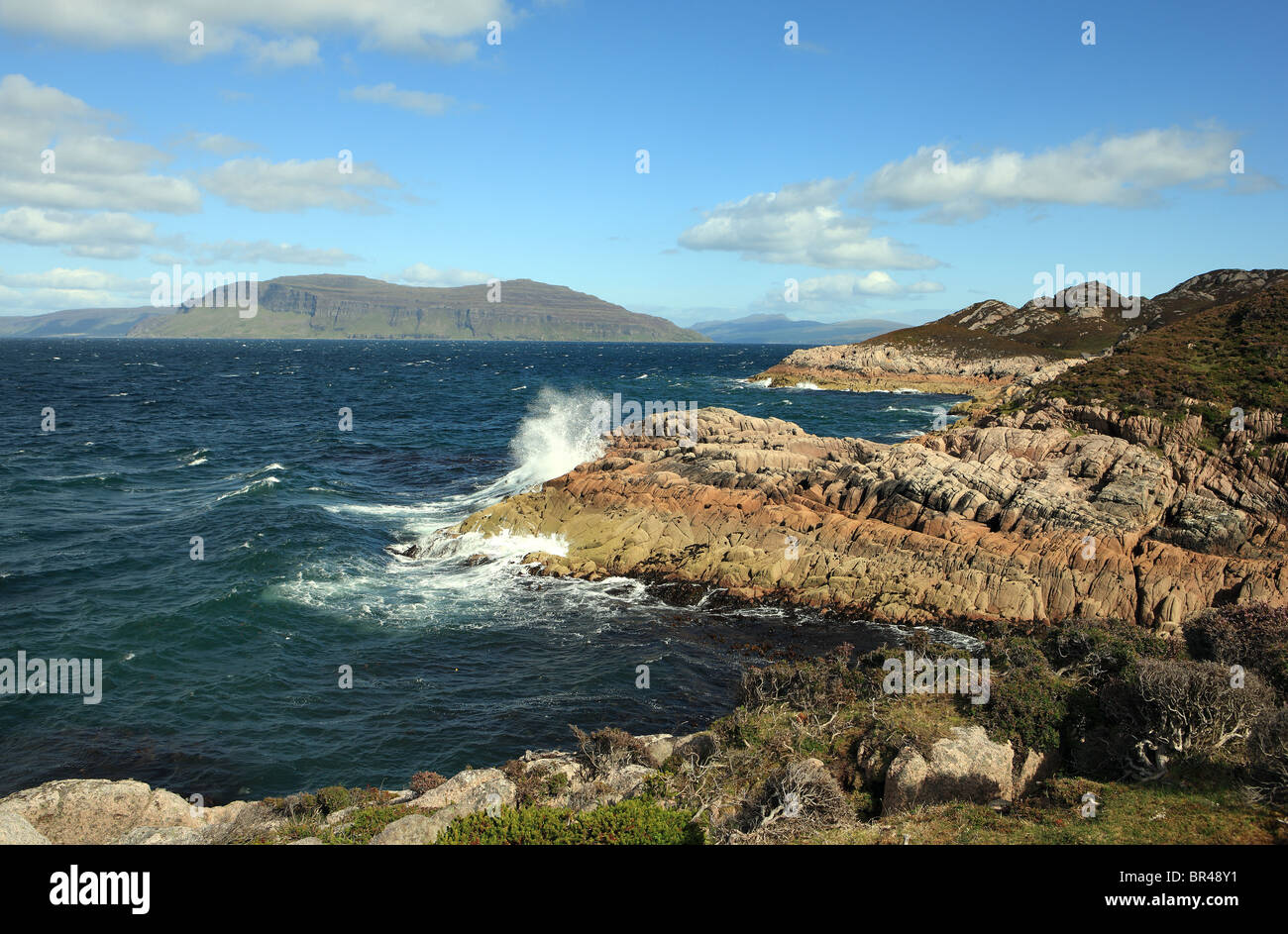 Waves crashing on pink granite rocks on the Isle of Mull Stock Photo ...