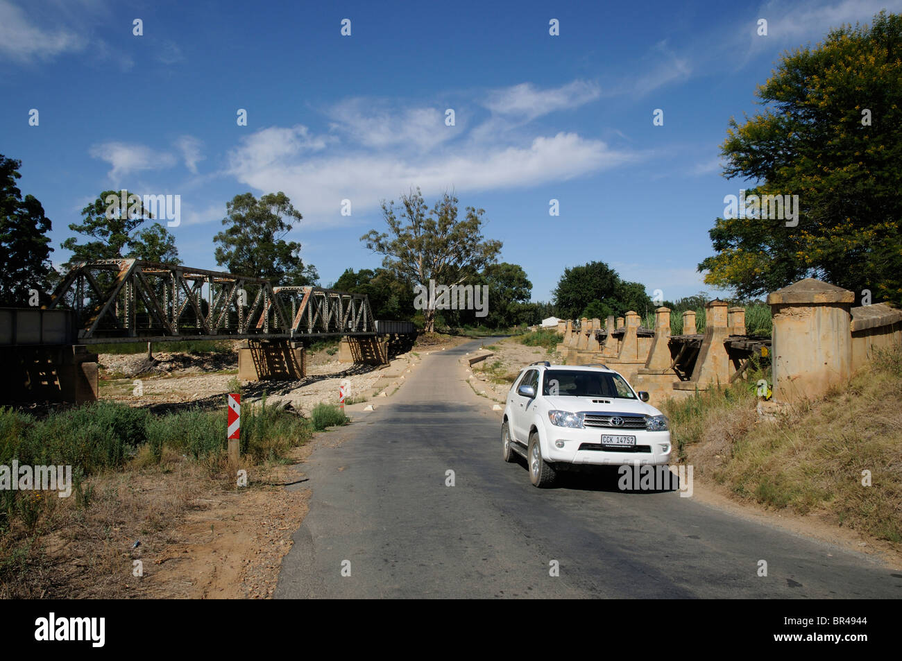 Steel railway bridge passing over the part dried riverbed of the ...