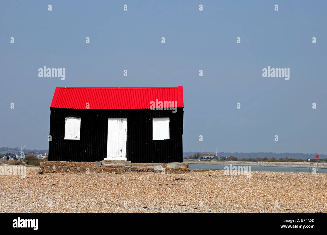 Fishermans hut with a bright red roof on the beach at Rye harbour, East ...