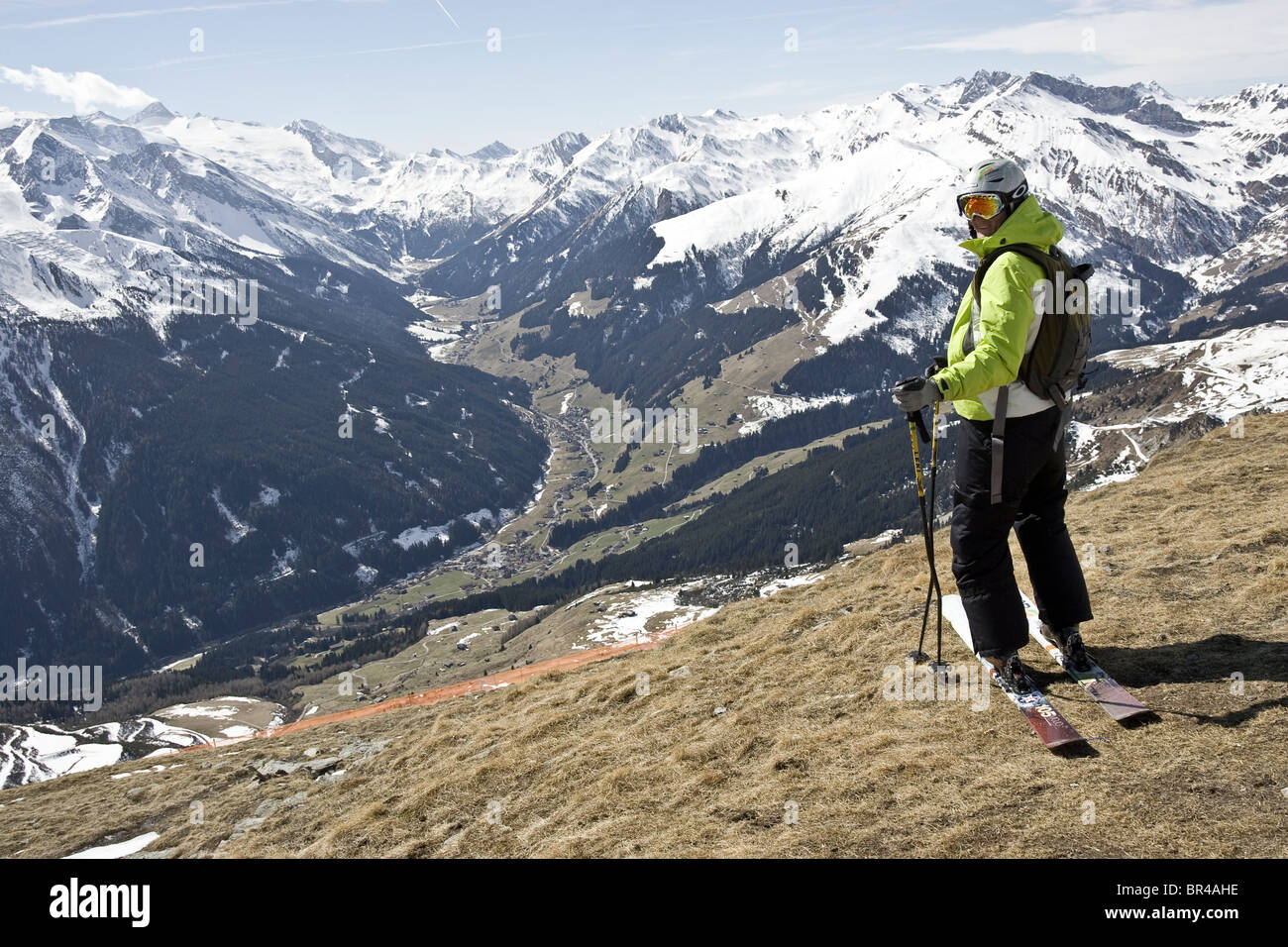 A man pauses at the top of a snowless ski trail in Mayrhofen, Austria ...