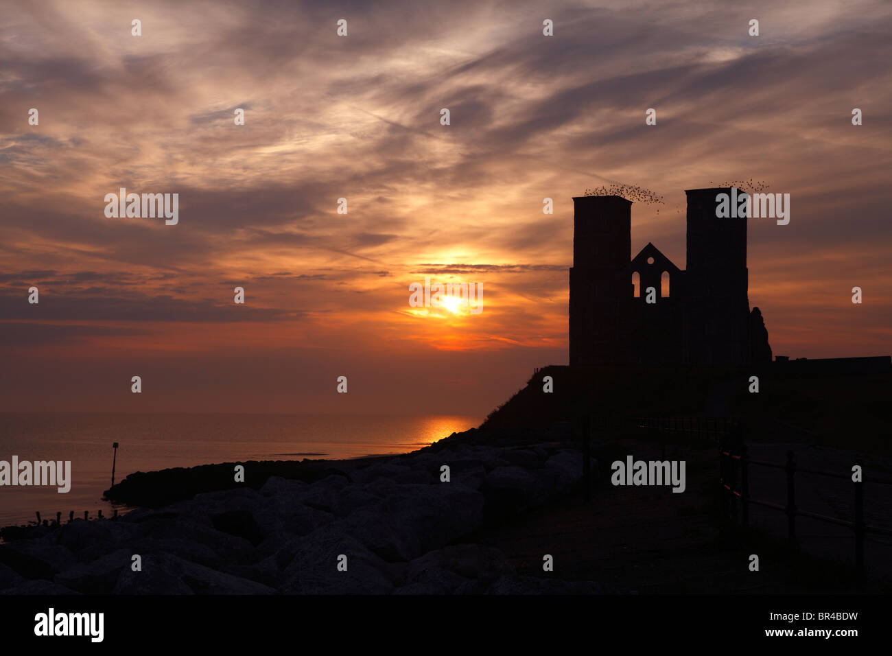 Sunrise at Reculver Towers and the Thames estuary in Kent, a flock of ...