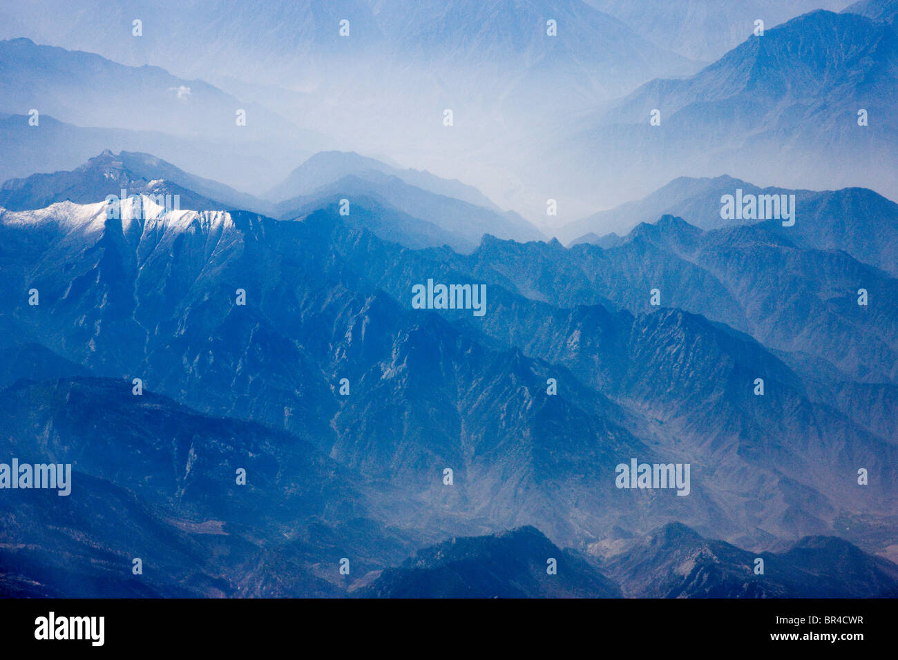 Aerial view of mountain range and clouds on the Pamir Plateau ...
