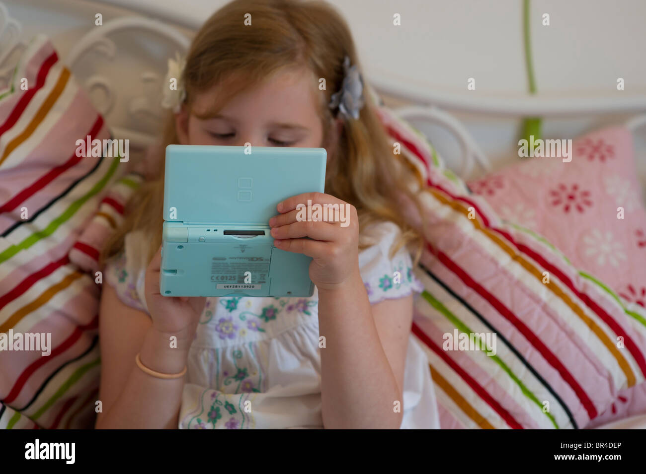 Young Caucasian girl sitting playing on a Nintendo DS Stock Photo - Alamy