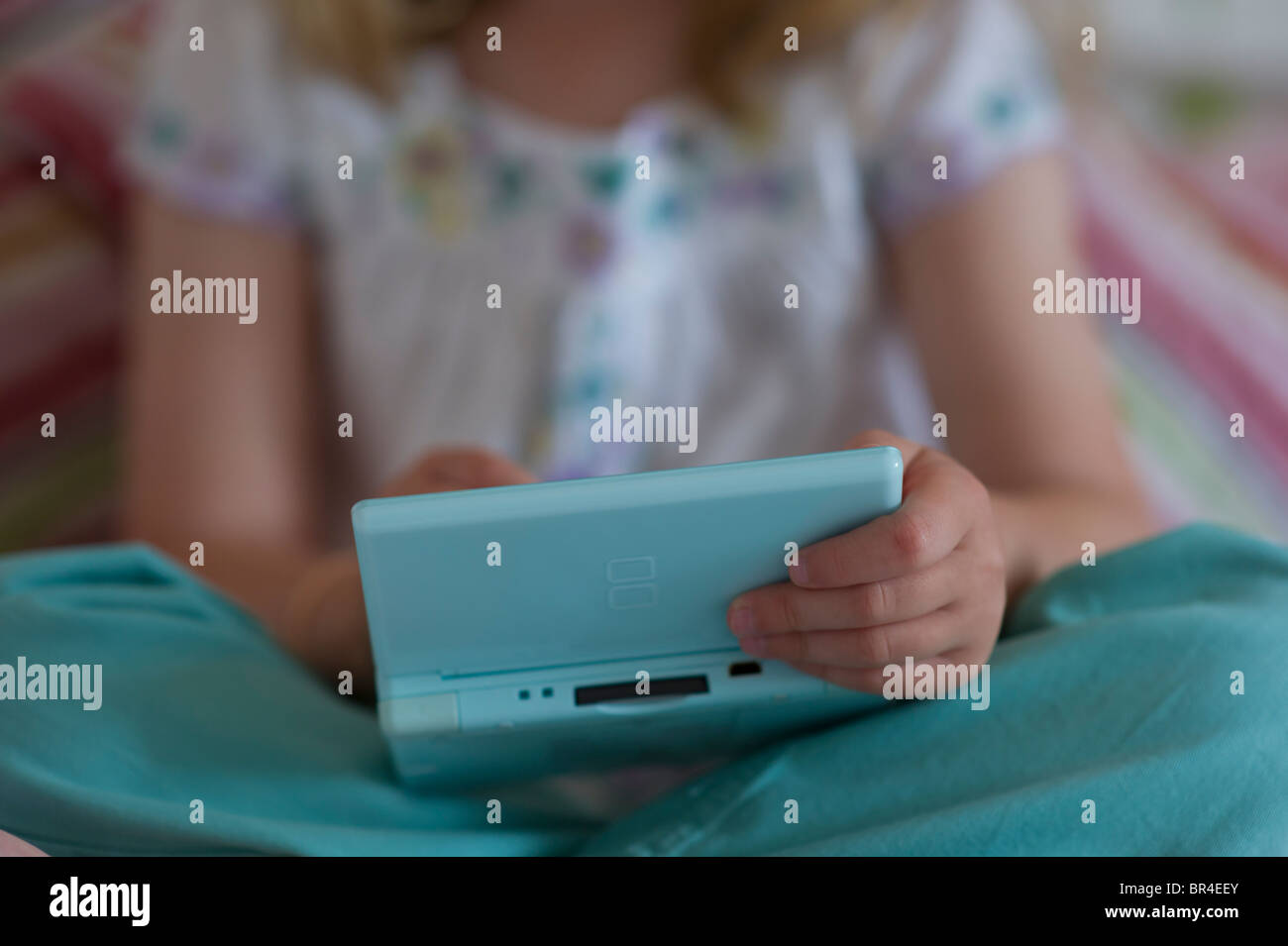 Young Caucasian girl sitting playing on a Nintendo DS Stock Photo - Alamy