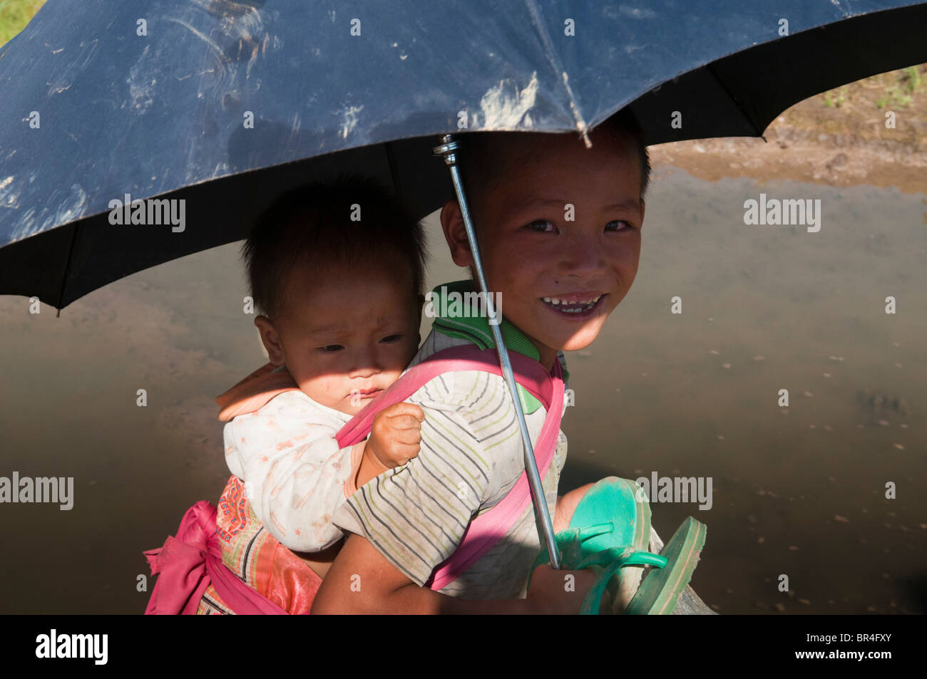 young boy and his brother posing for their first photo in rural Laos ...