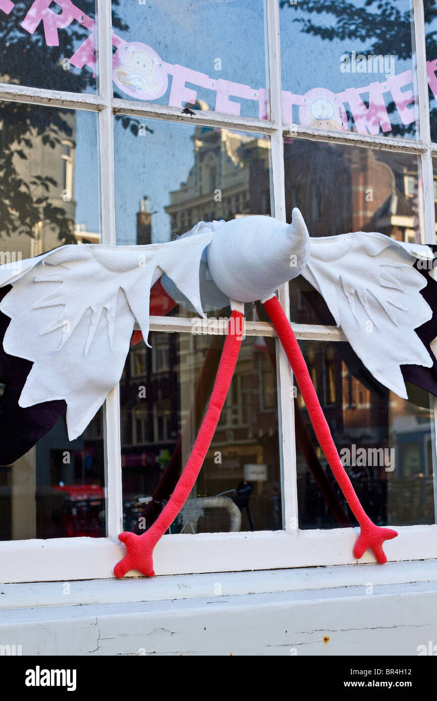 Joke figure of a bird looking through a shop window in Amsterdam ...