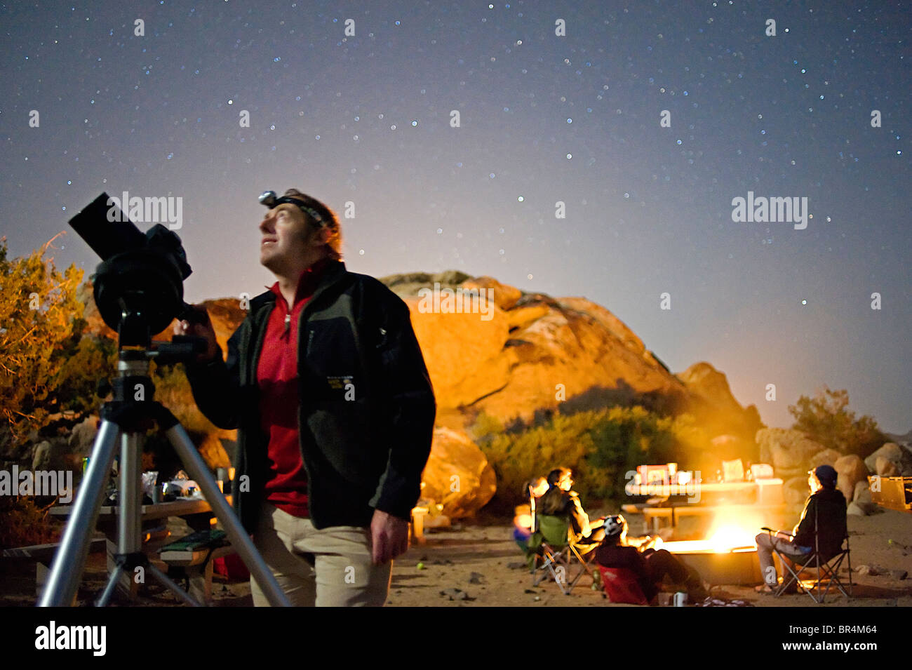 A man and telescope at Joshua Tree Stock Photo - Alamy