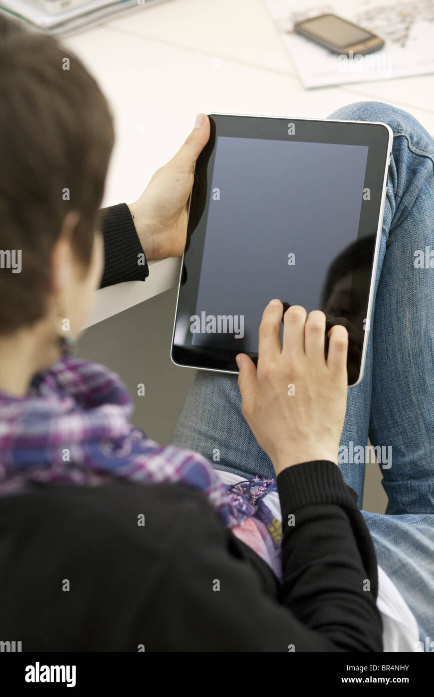 Young woman using iPad Stock Photo - Alamy