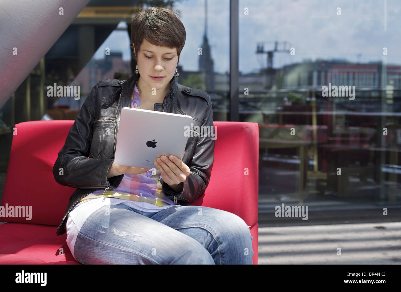 Young woman using iPad Stock Photo - Alamy
