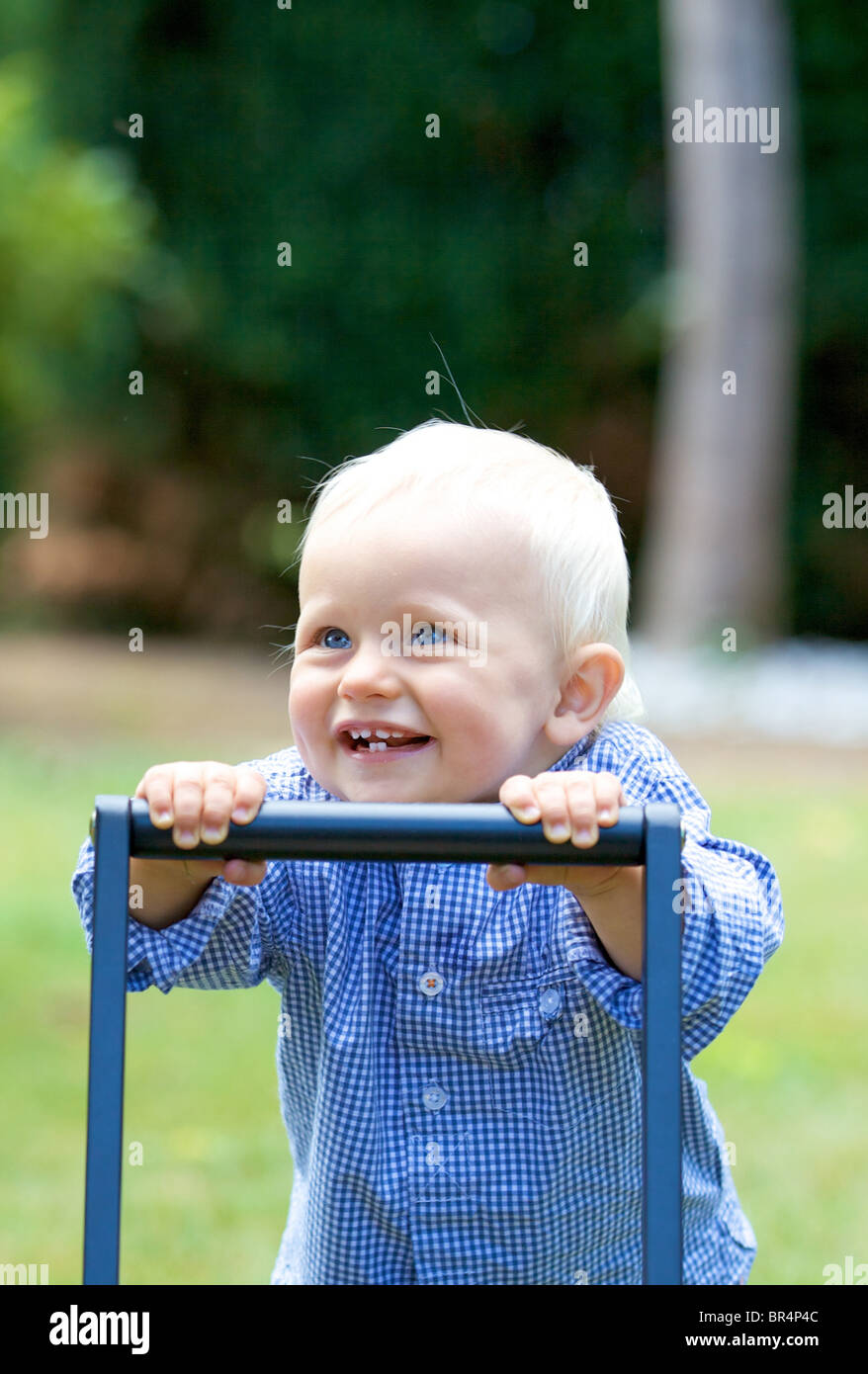 Toddler walking with walking aid Stock Photo - Alamy
