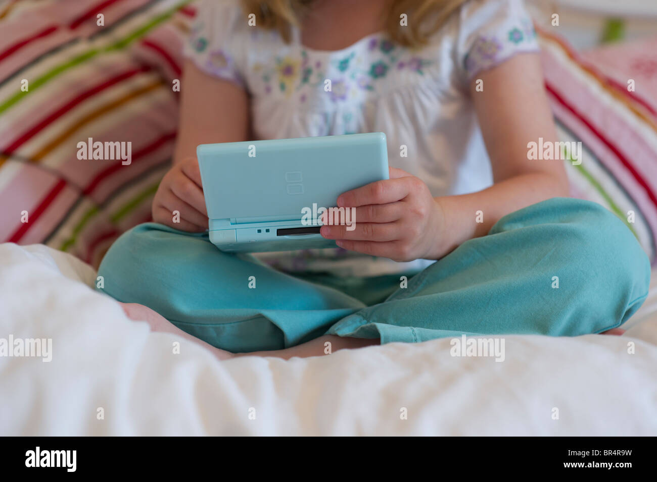 Young Caucasian girl sitting playing on a Nintendo DS Stock Photo - Alamy
