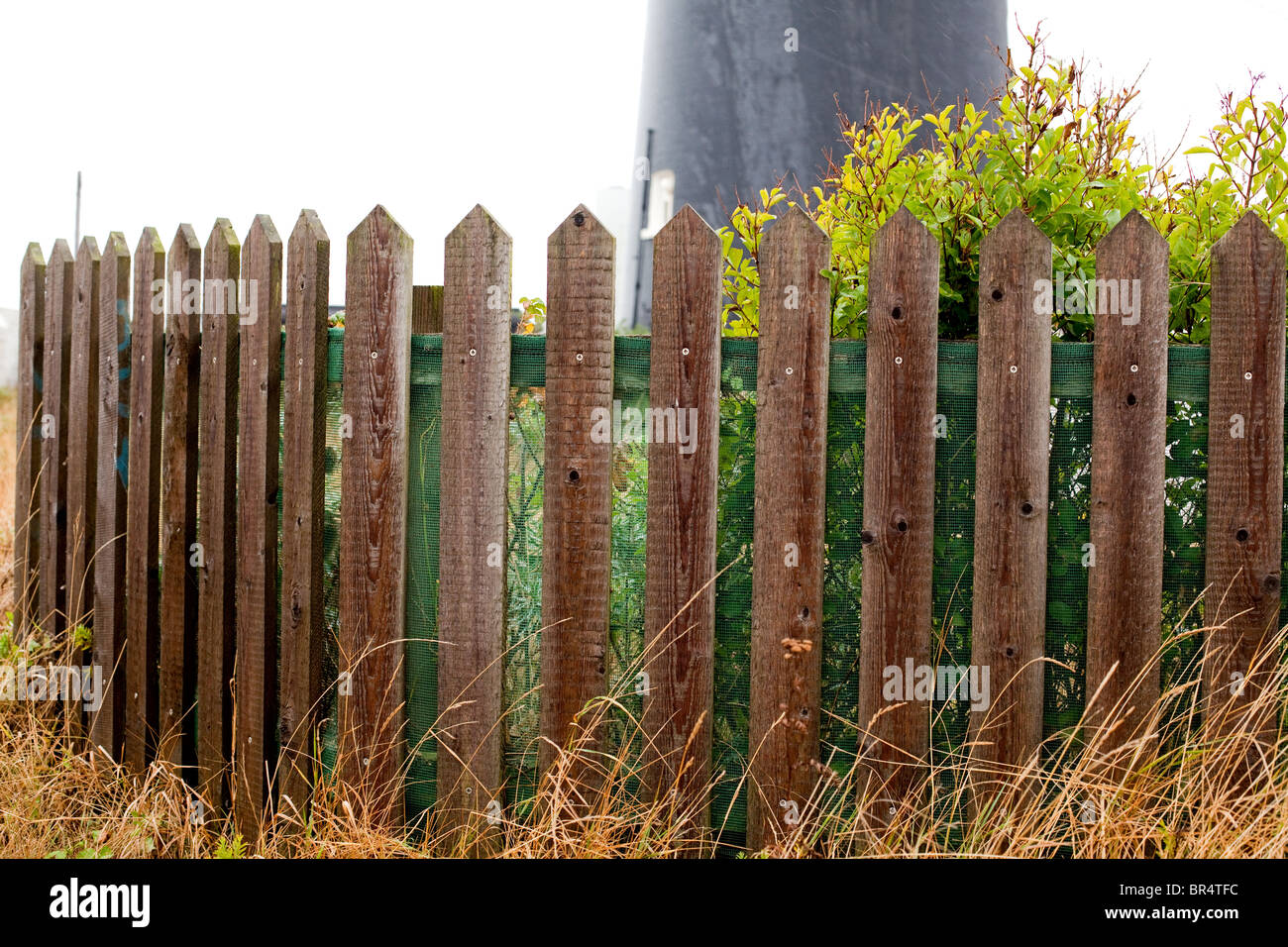 A wooden psling fence around the Old Lighthouse in Dungeness Kent ...