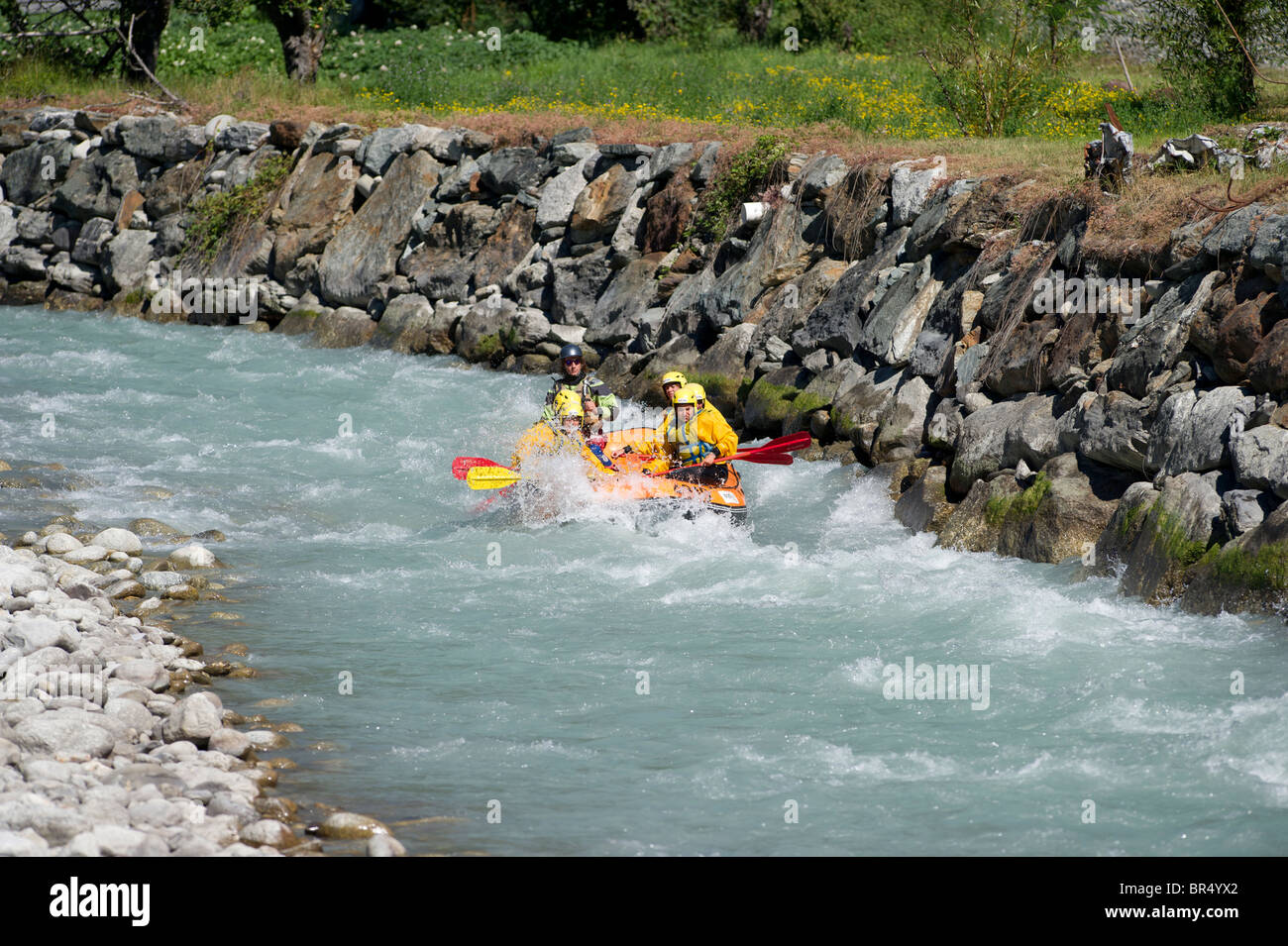 Tourists try whitewater rafting through small rapids in the Italian ...