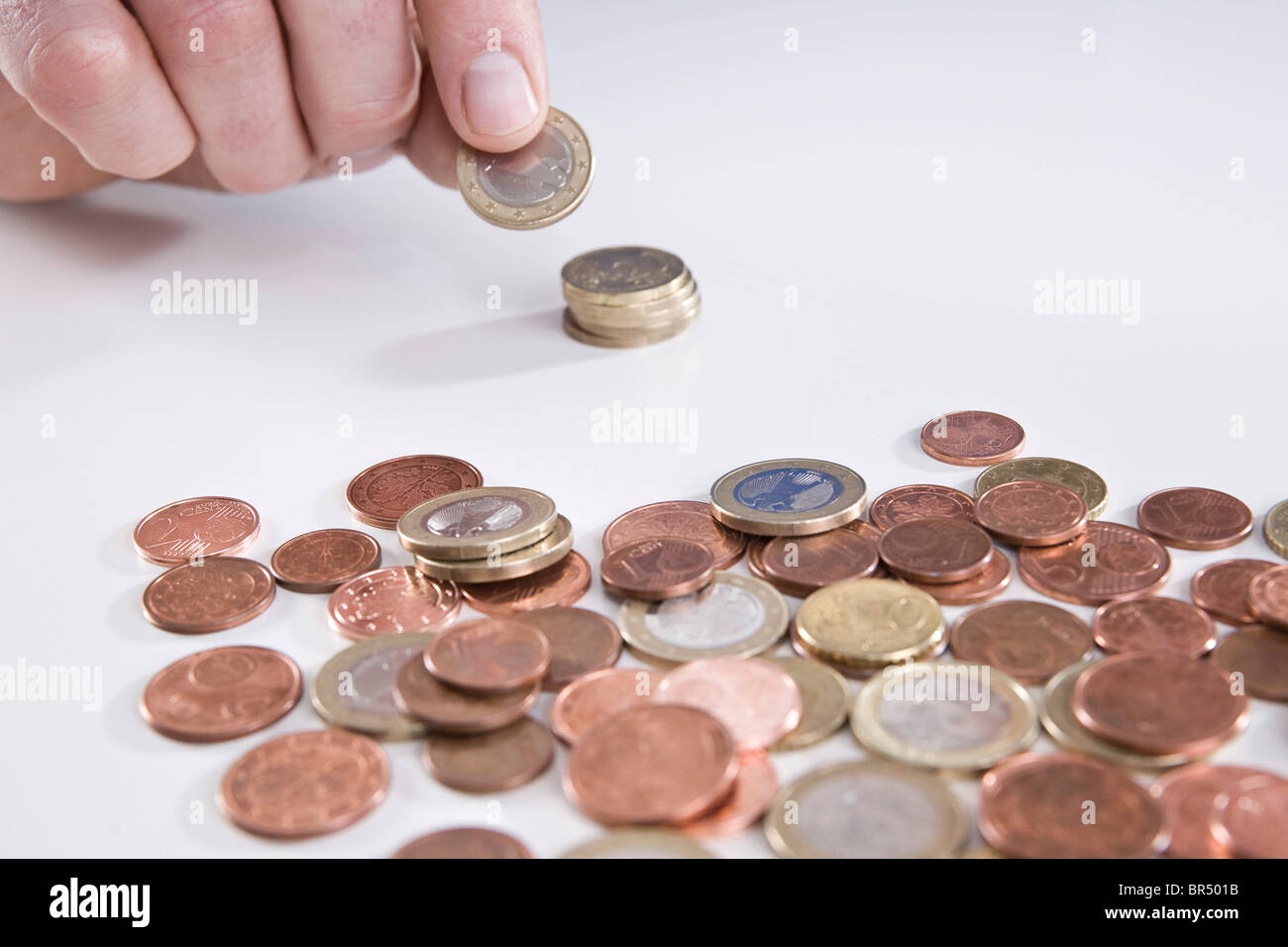 Hand stacking coins Stock Photo - Alamy