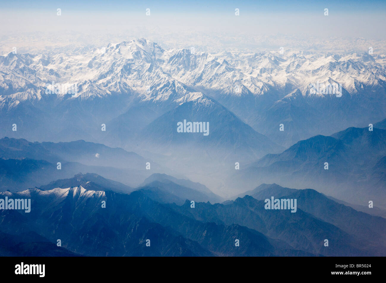 Aerial view of mountain range and clouds on the Pamir Plateau ...