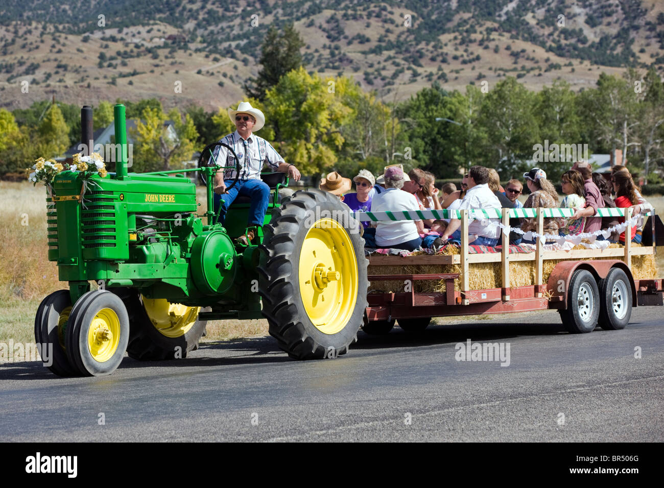 Wedding procession, ranch family riding on antique tractors from the ...