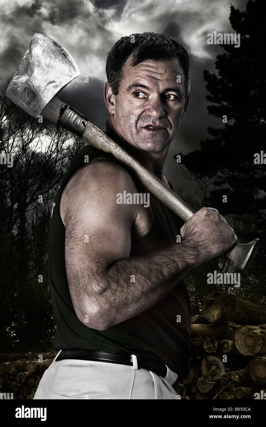 A man rests an axe on his shoulder during traditional rural sport ...