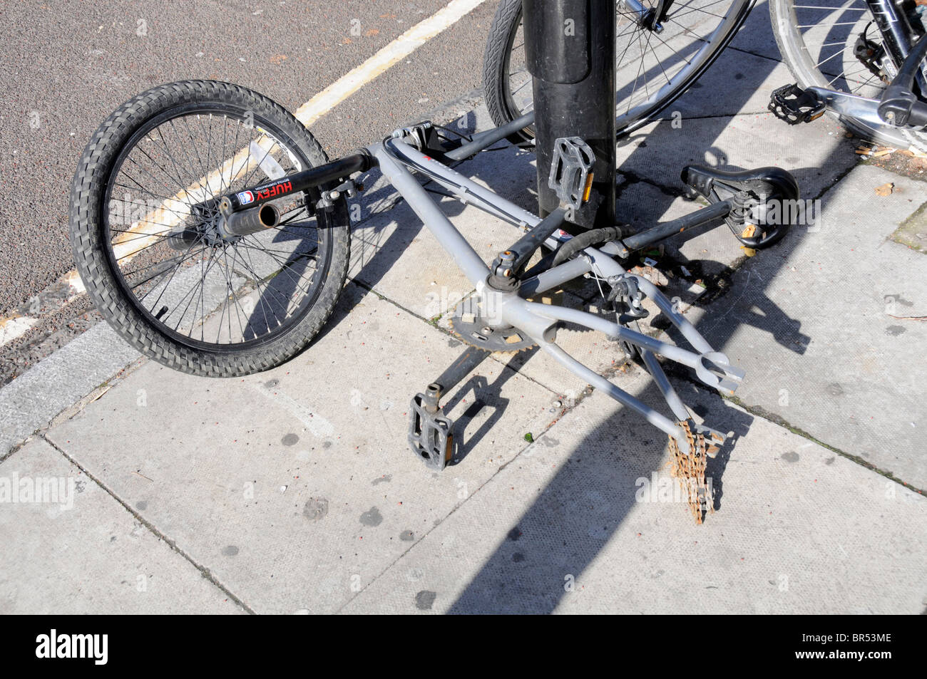 BICYCLE WITH STOLEN WHEEL IN STREET IN LONDON UK Stock Photo - Alamy