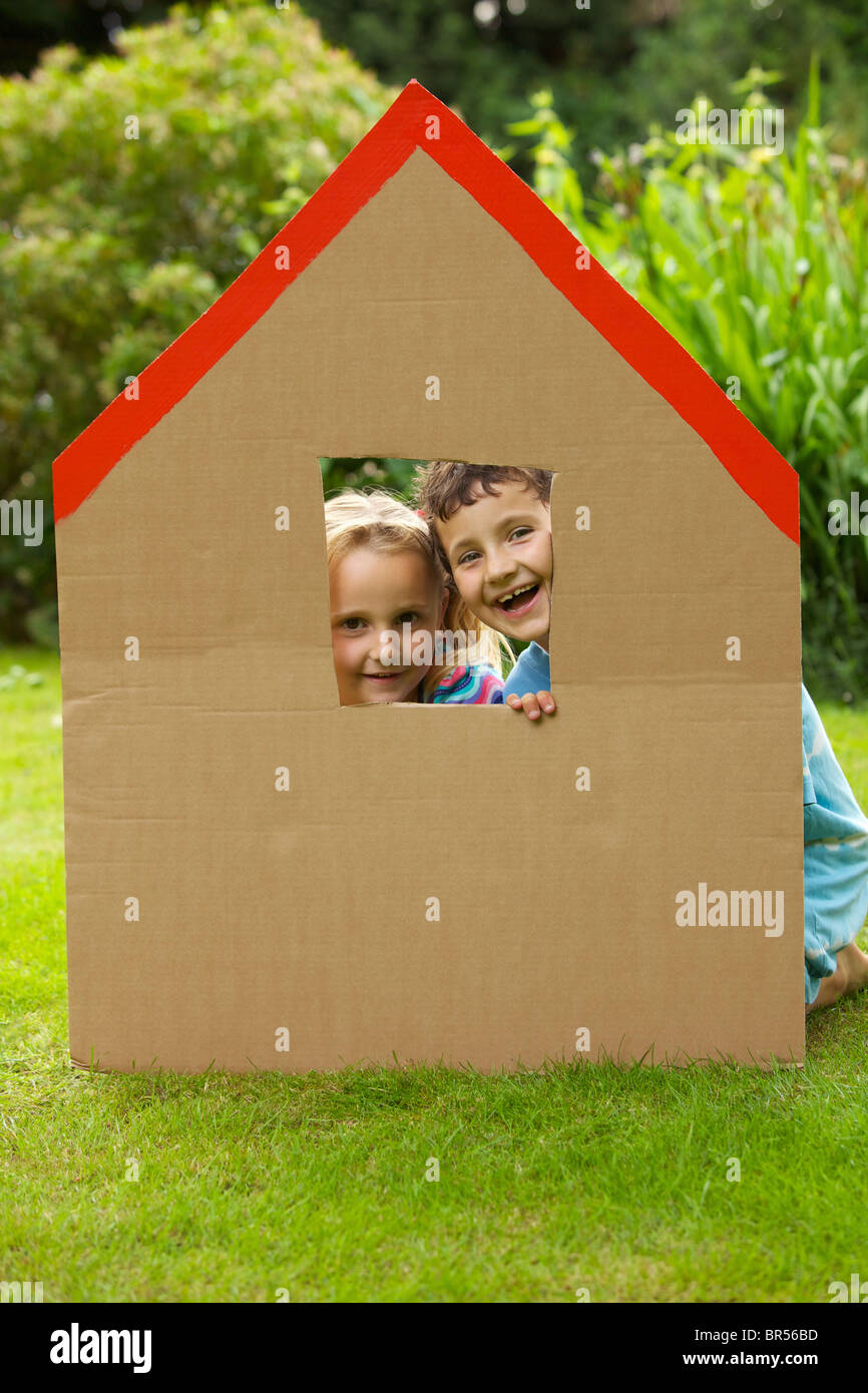 Happy children looking out of the window of their house hi-res stock ...