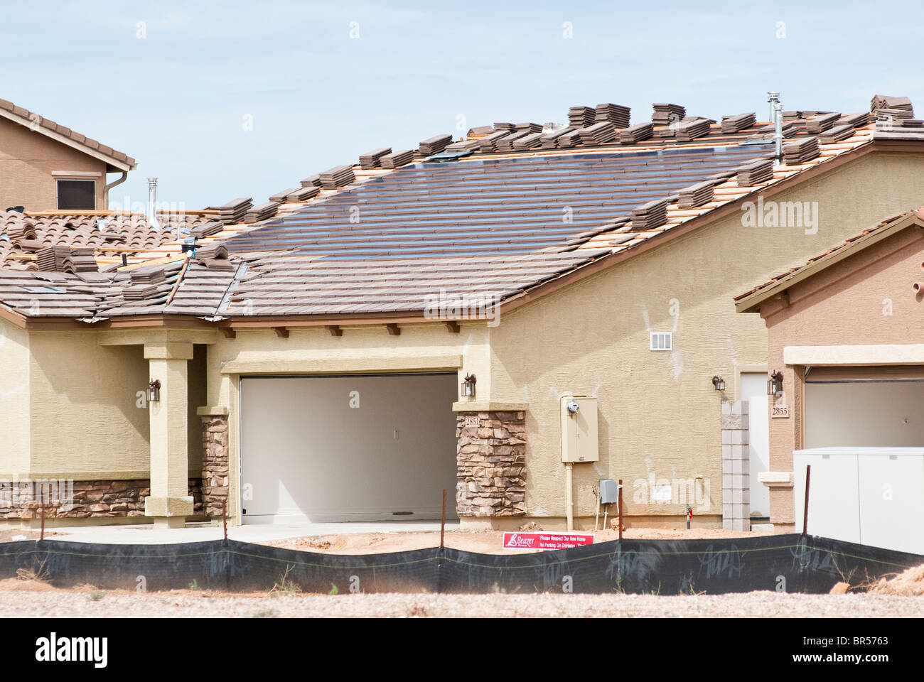 Integral solar roofing panels are being built into the roof of a new ...