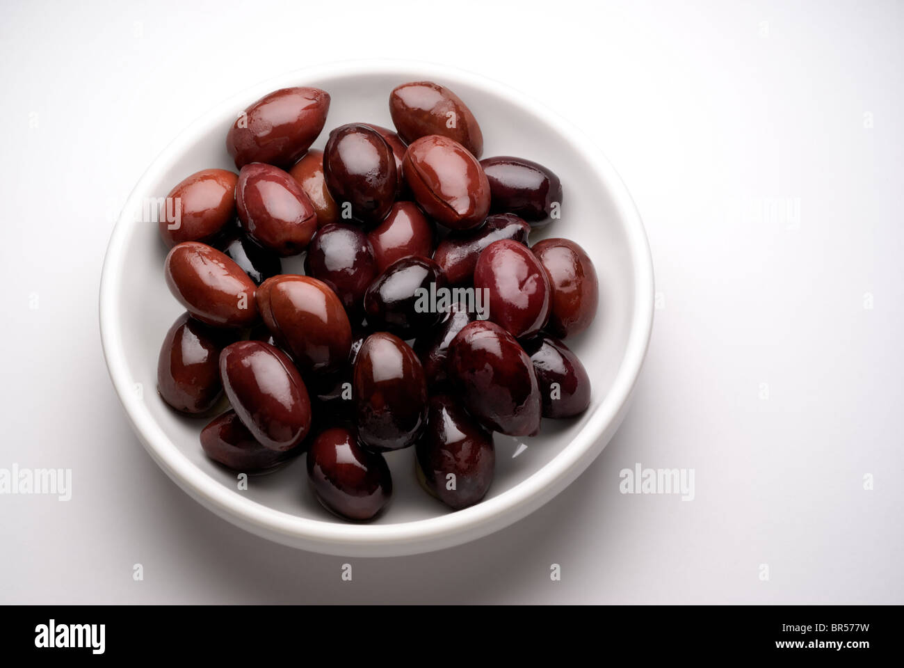 Kalamata black olives in a dish Stock Photo - Alamy