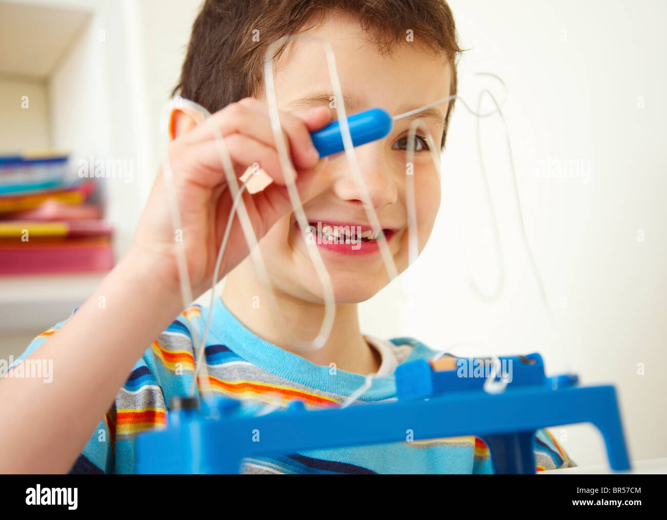 Boy Playing with Wire Coordination Game Stock Photo - Alamy
