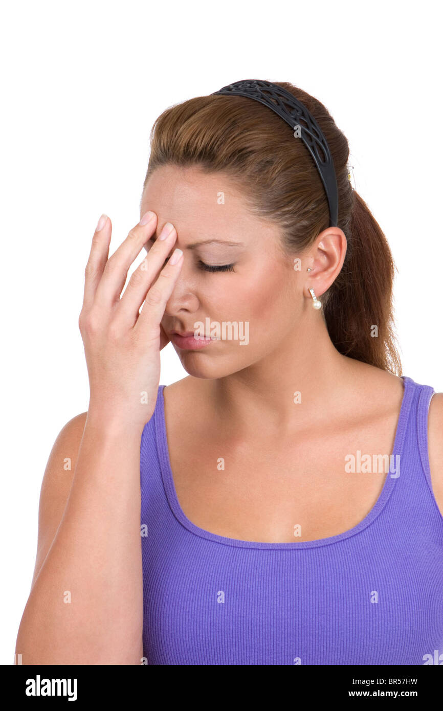 Young woman holds her hand to head trying to cope with a stressful ...