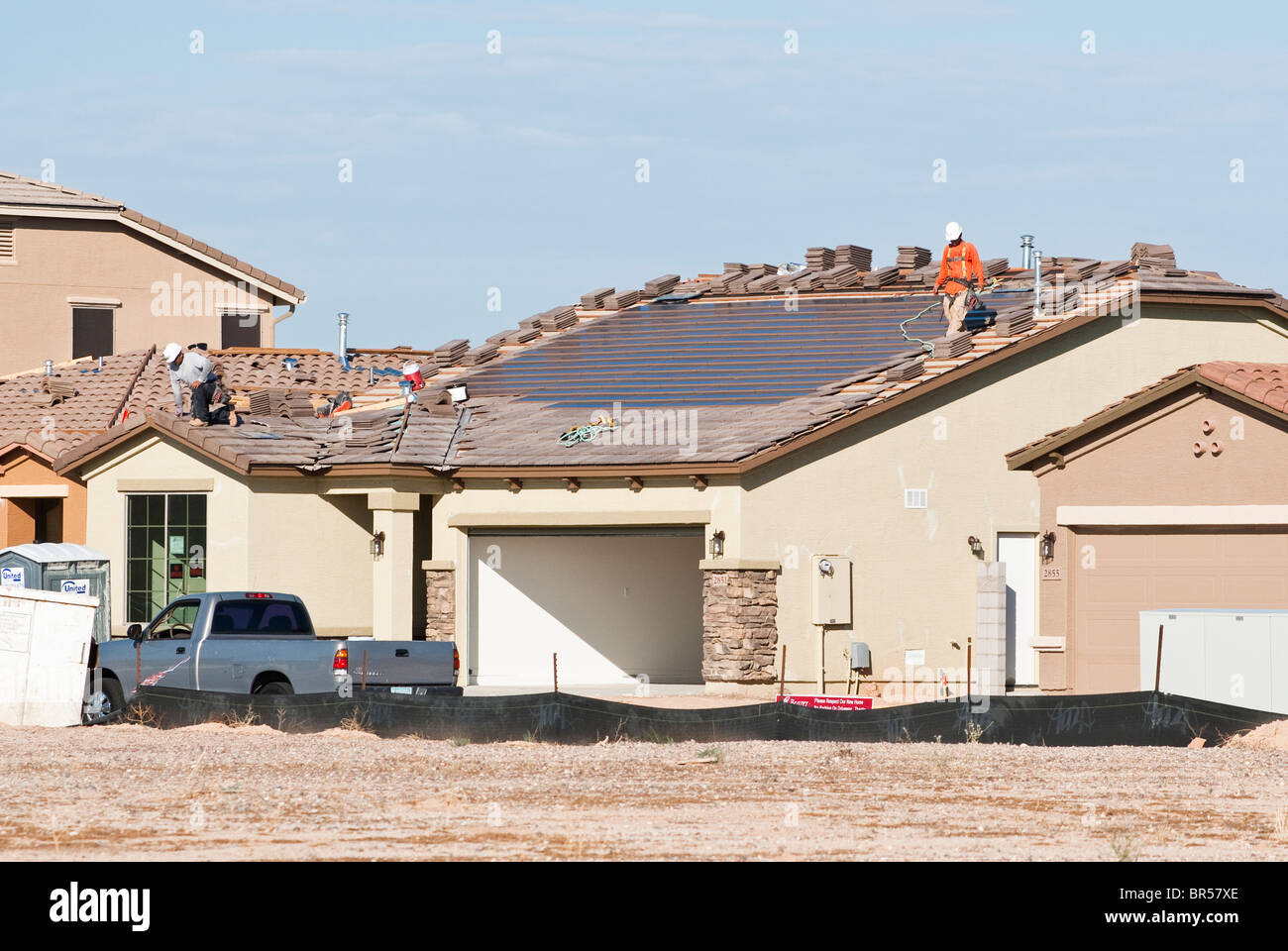 Integral solar roofing panels are being built into the roof of a new ...