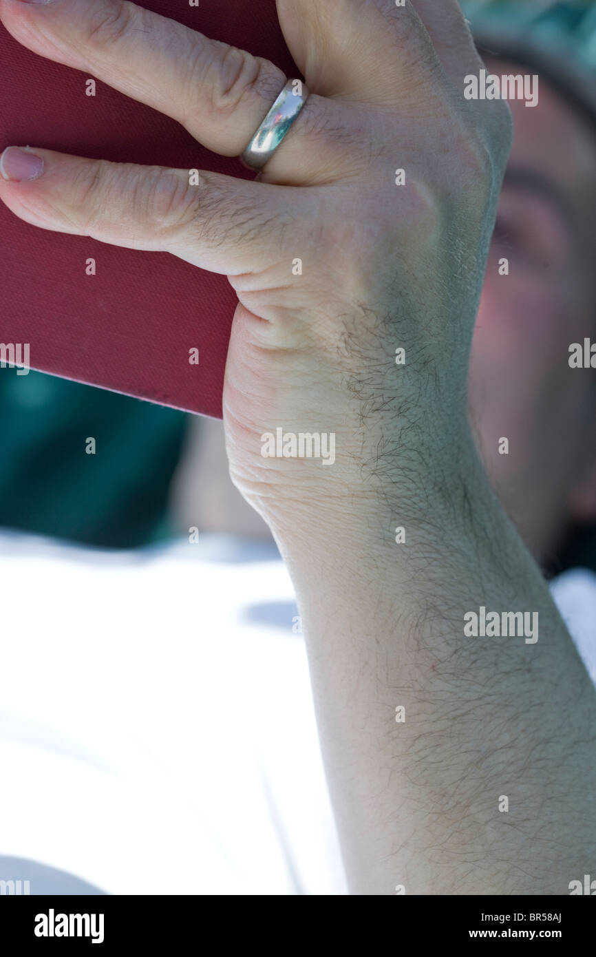 Mans hand holding book hi-res stock photography and images - Alamy