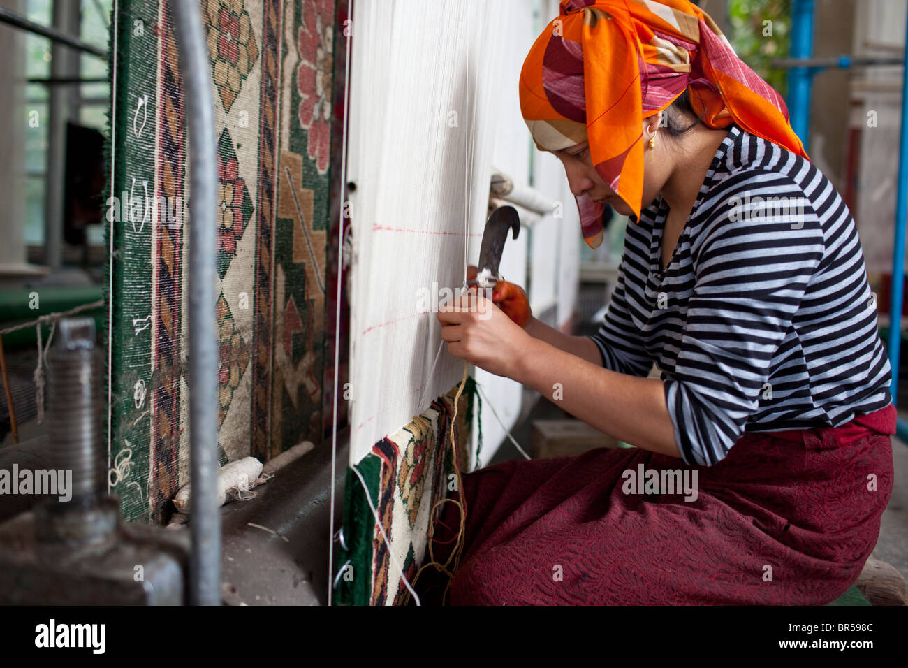 Young women working in a carpet factory outside Hotan Xinjiang China ...