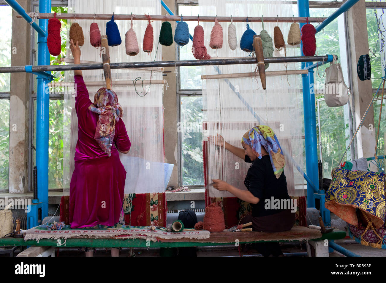 Young women working in a carpet factory outside Hotan Xinjiang China ...