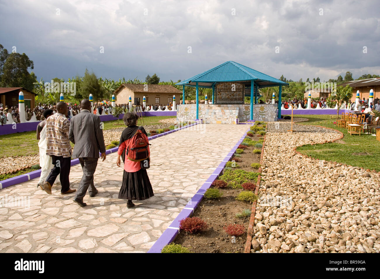 The Rwandan Minister of Culture and an artist and activist approach the ...