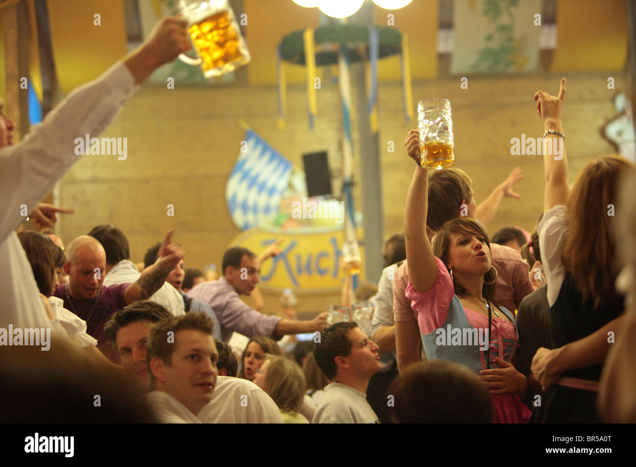Revelers raise their beer steins to toast at Oktoberfest Munich Bavaria ...