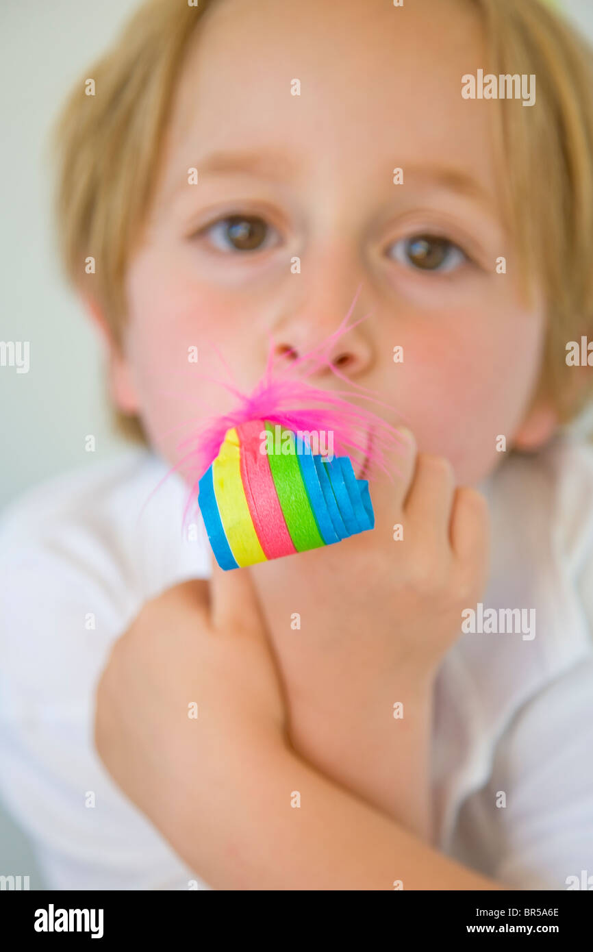 Boy blowing party blower hi-res stock photography and images - Alamy