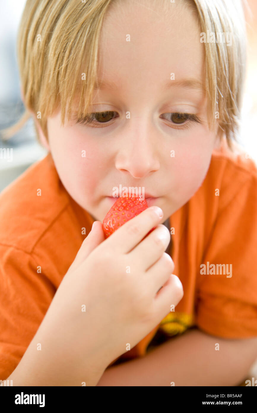 Young Boy Eating Strawberry Stock Photo - Alamy