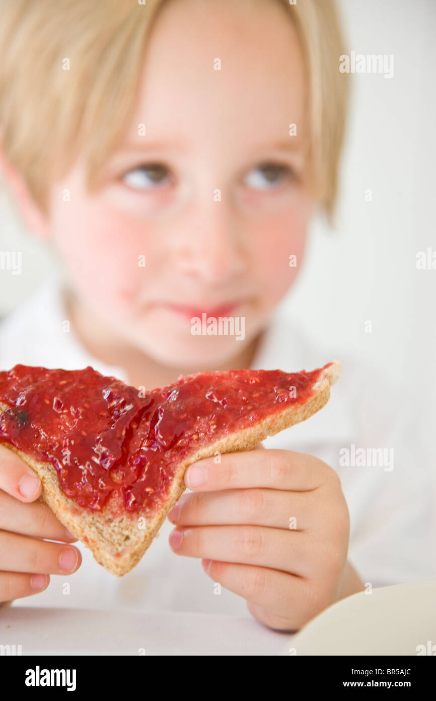Kid eating jam on toast hi-res stock photography and images - Alamy