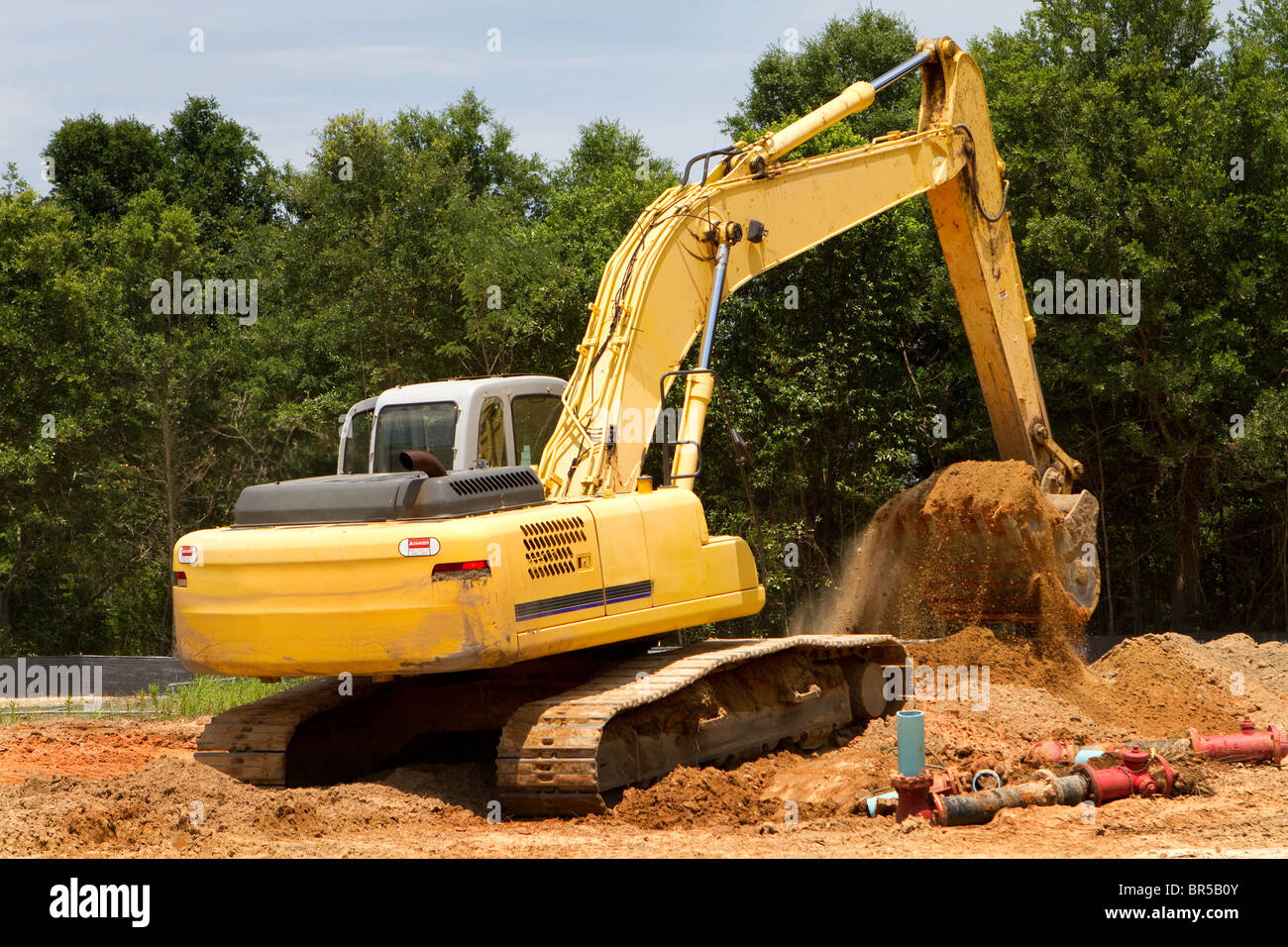Backhoe machine uses shovel scooper to excavate and move dirt Stock ...