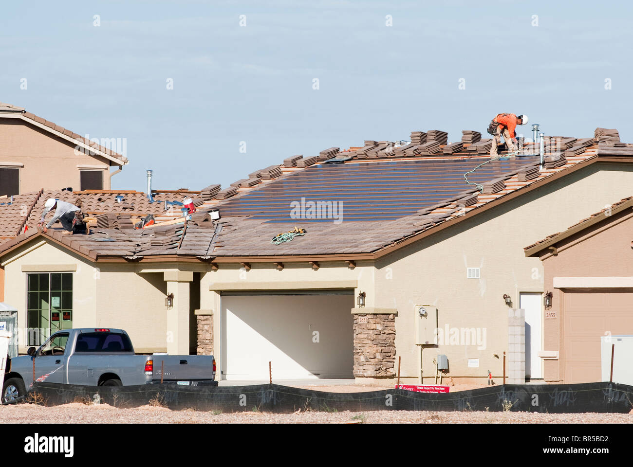 Integral solar roofing panels are being built into the roof of a new ...