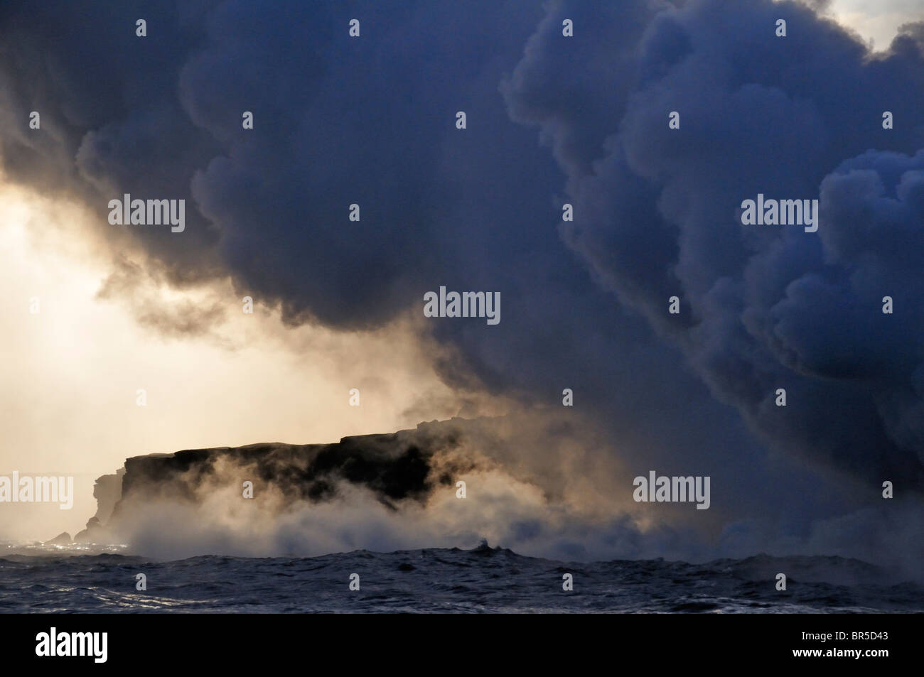 Steam rising off lava flowing into ocean at sunset, Kilauea Volcano ...