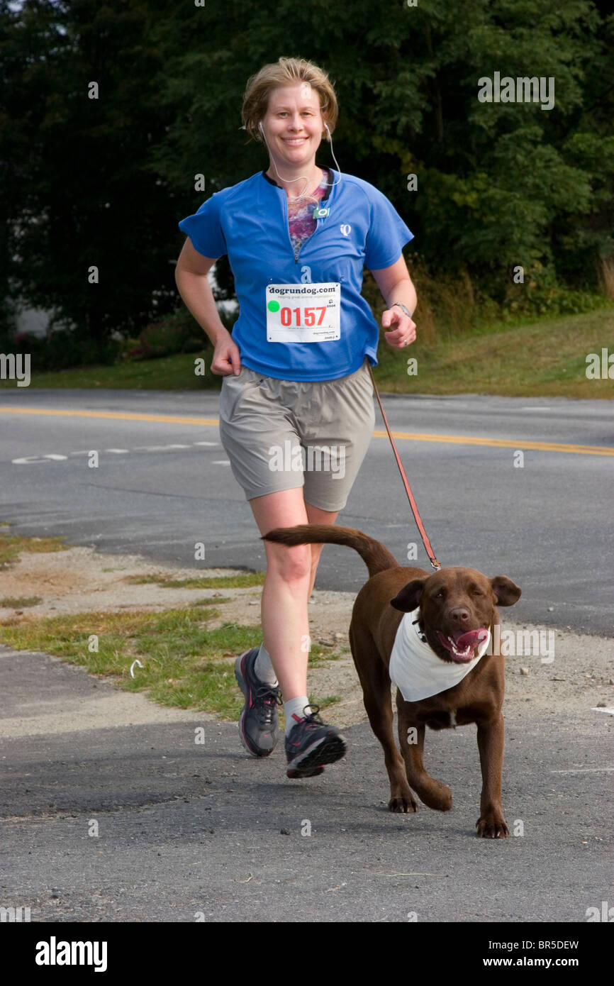 Female woman running race with dog in race Stock Photo - Alamy