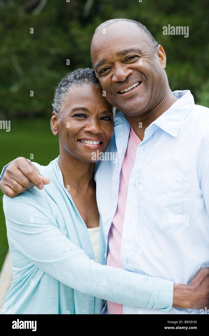 Smiling African American couple hugging Stock Photo - Alamy