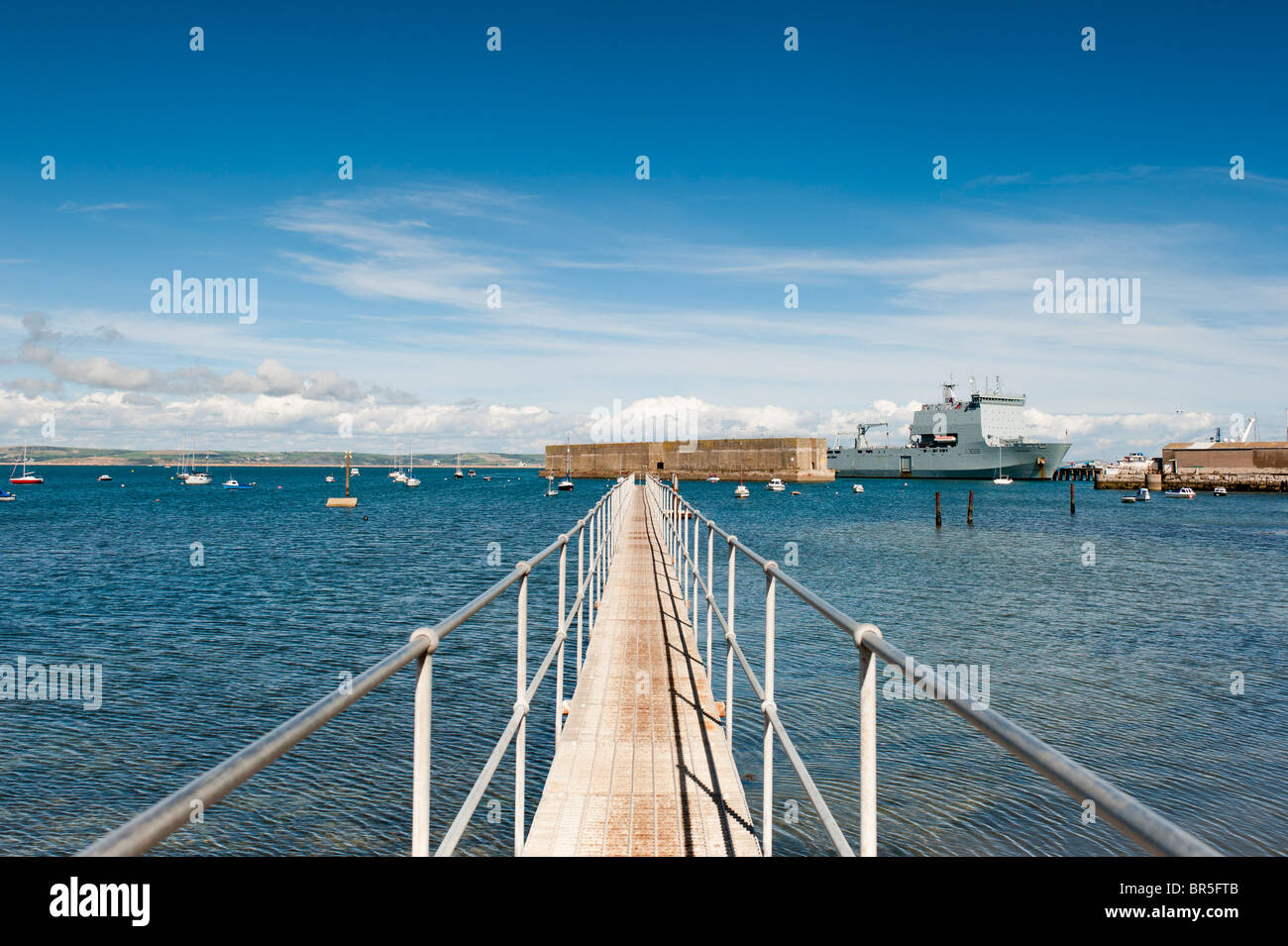 Jetty, Portland Harbour. The Royal Fleet Axillary ship Largs Bay can be ...