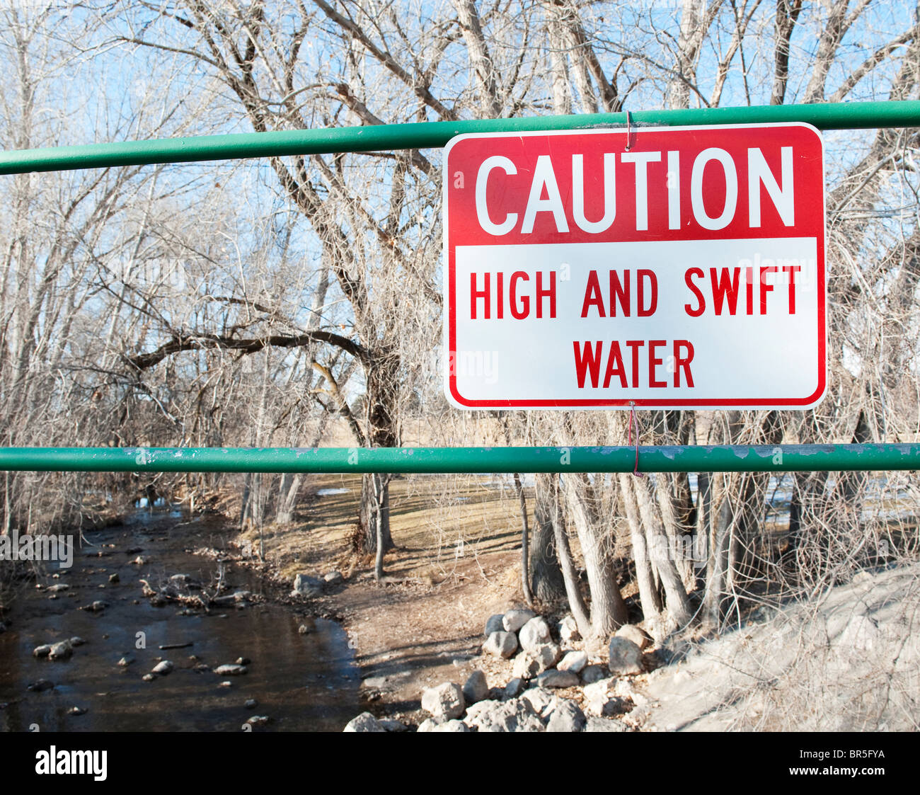 Sign warning of high and swift water near a stream Stock Photo - Alamy
