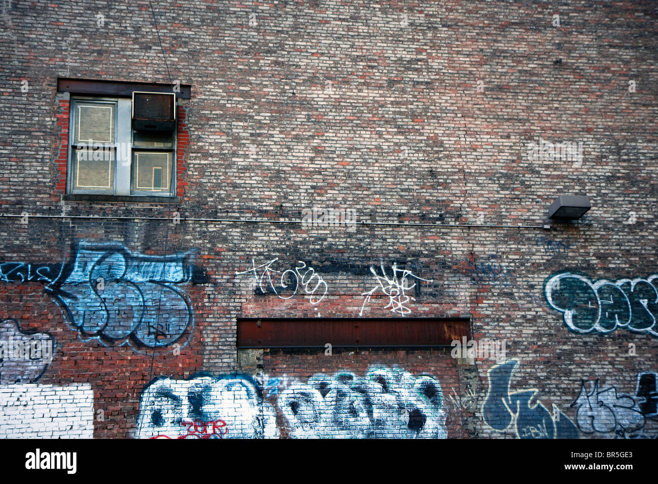 Wall with a window and graffiti Stock Photo - Alamy